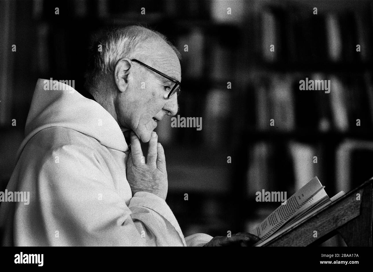 A monk reading a bible in the library at Sancta Maria Abbey at Nunraw ...