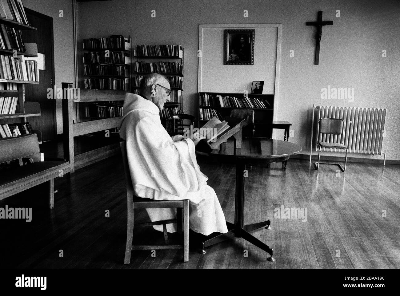 A monk reading a bible in the library at Sancta Maria Abbey at Nunraw ...
