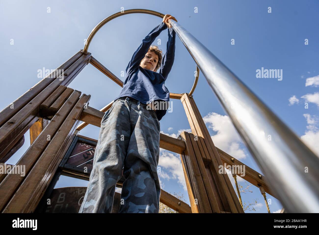 Kid adventure playground park. Bottom up portrait of a kid having fun ...