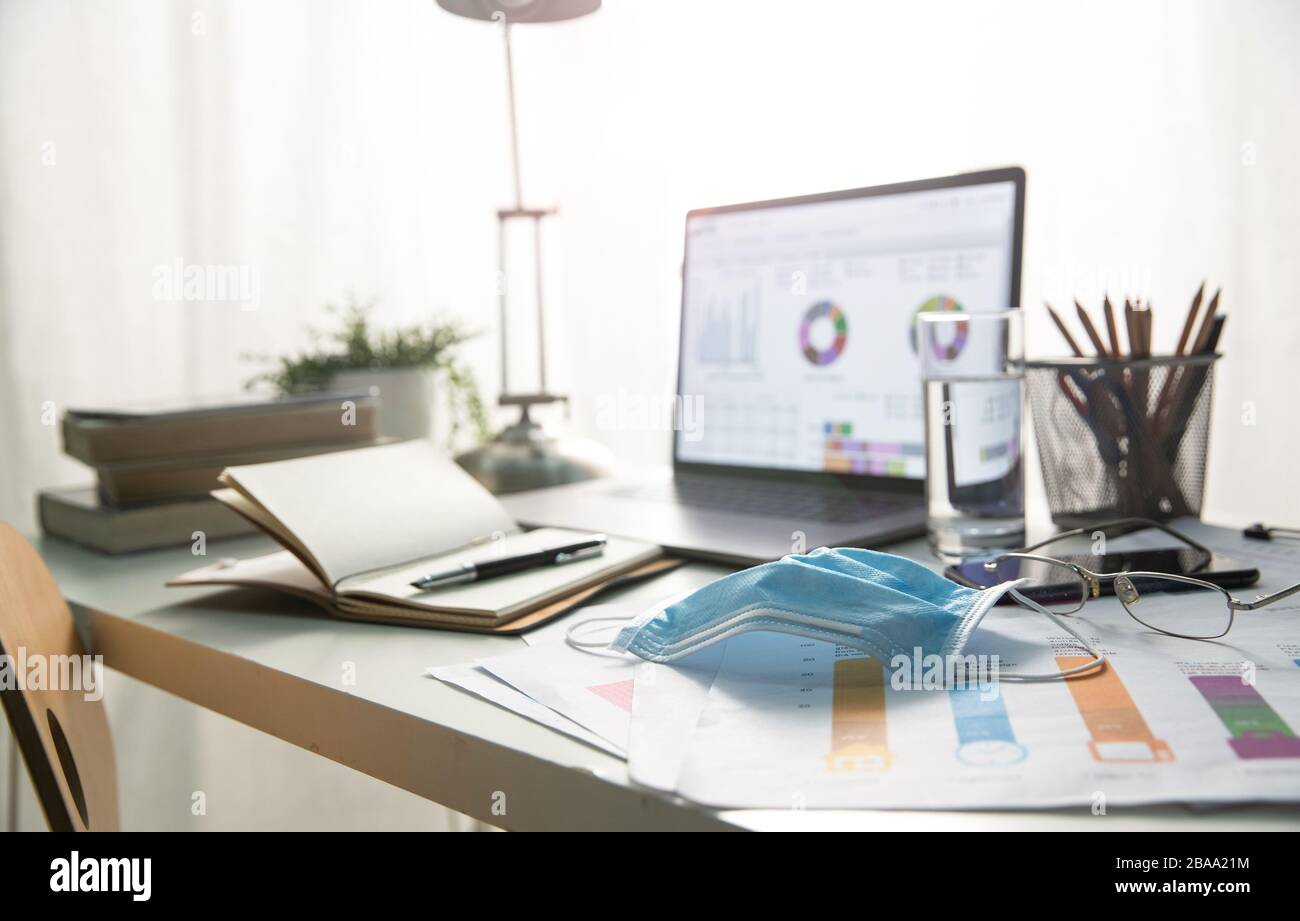 Office supplies and disposable masks on the desk Stock Photo - Alamy