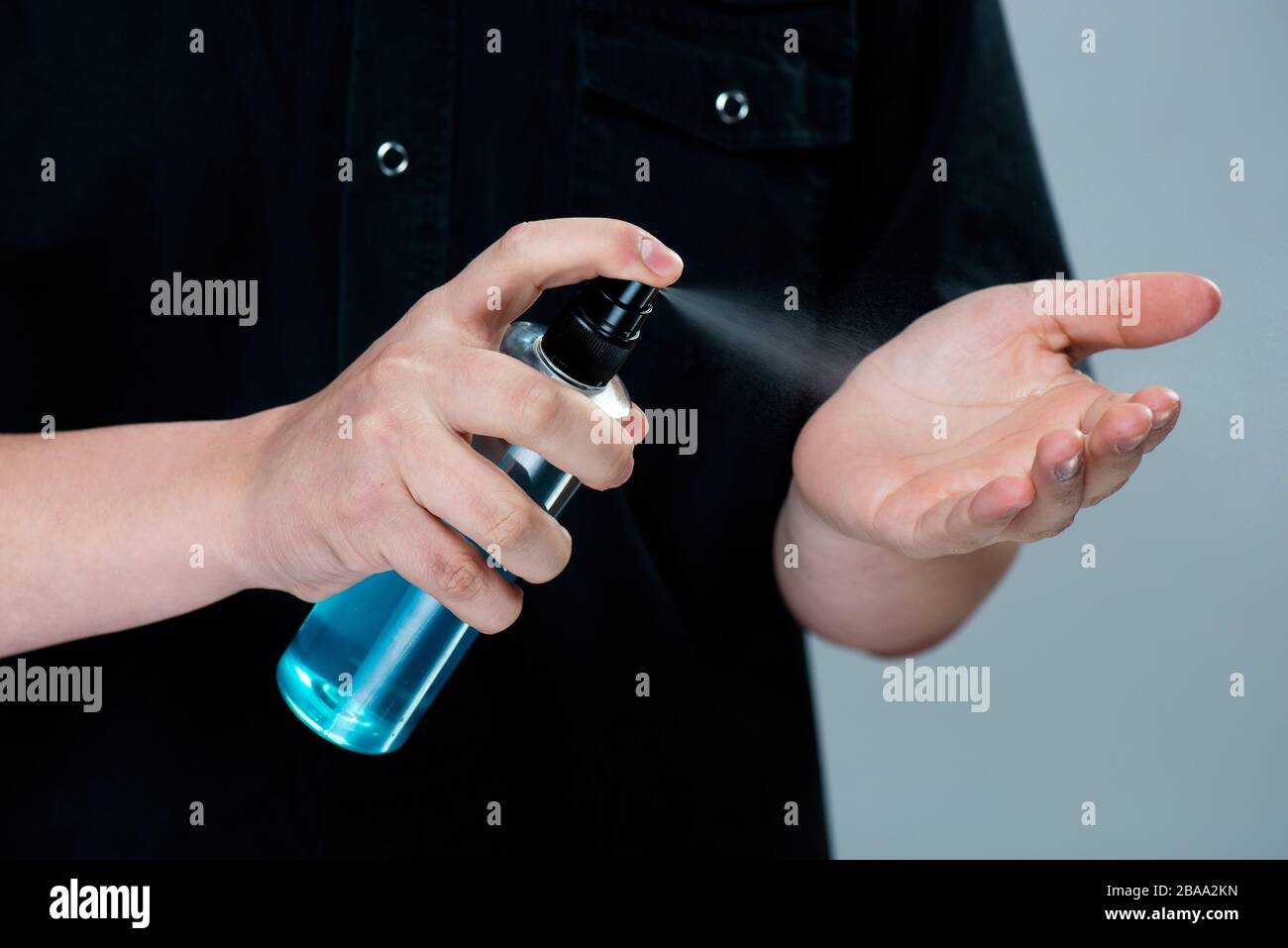Hand applying alcohol or anti bacteria spray to prevent spread germs ...