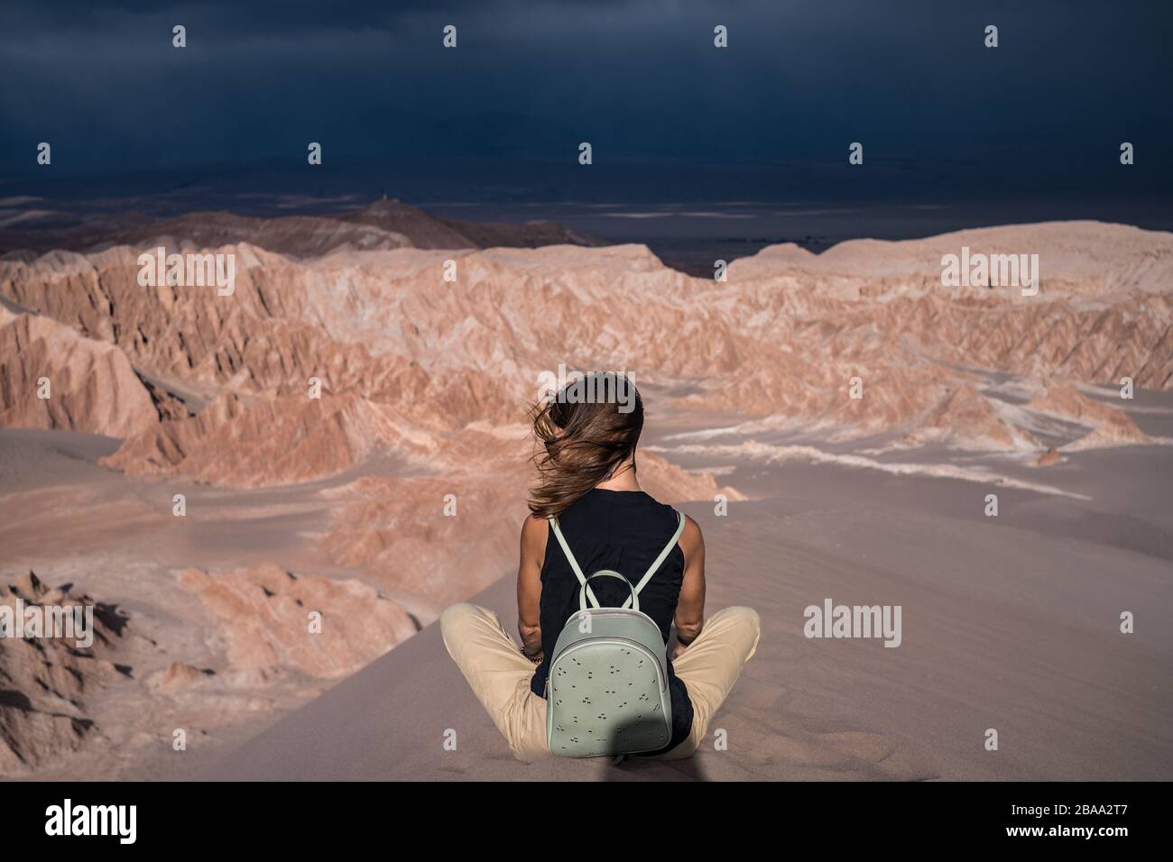 Woman sitting, enjoying dramatic scenery Stock Photo - Alamy
