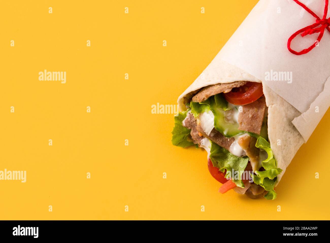 Doner kebab or shawarma sandwich isolated on yellow background. Top ...