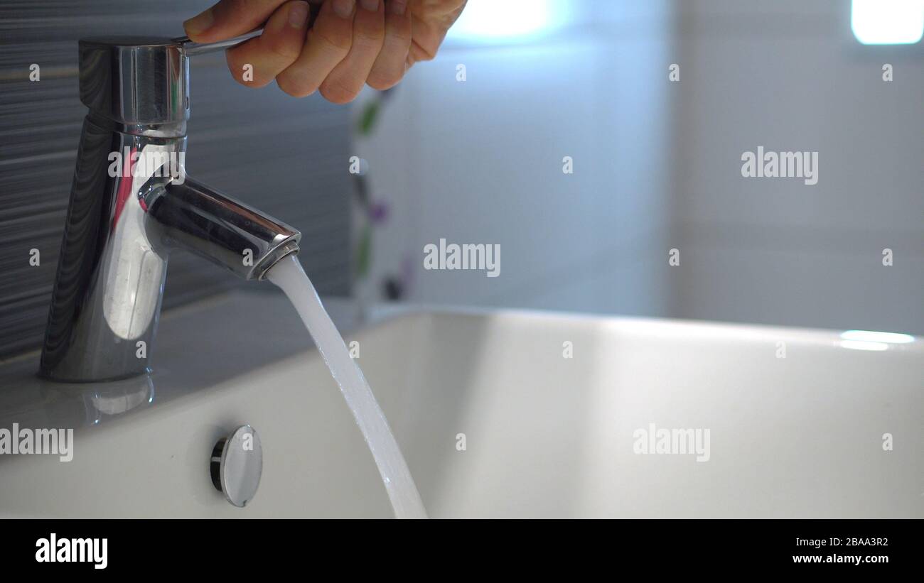 Hand opening water tap hi-res stock photography and images - Alamy