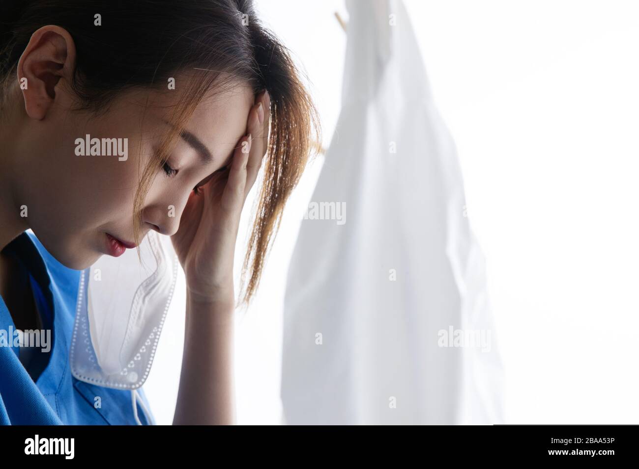 Exhausted young female doctor rub eyes Stock Photo - Alamy