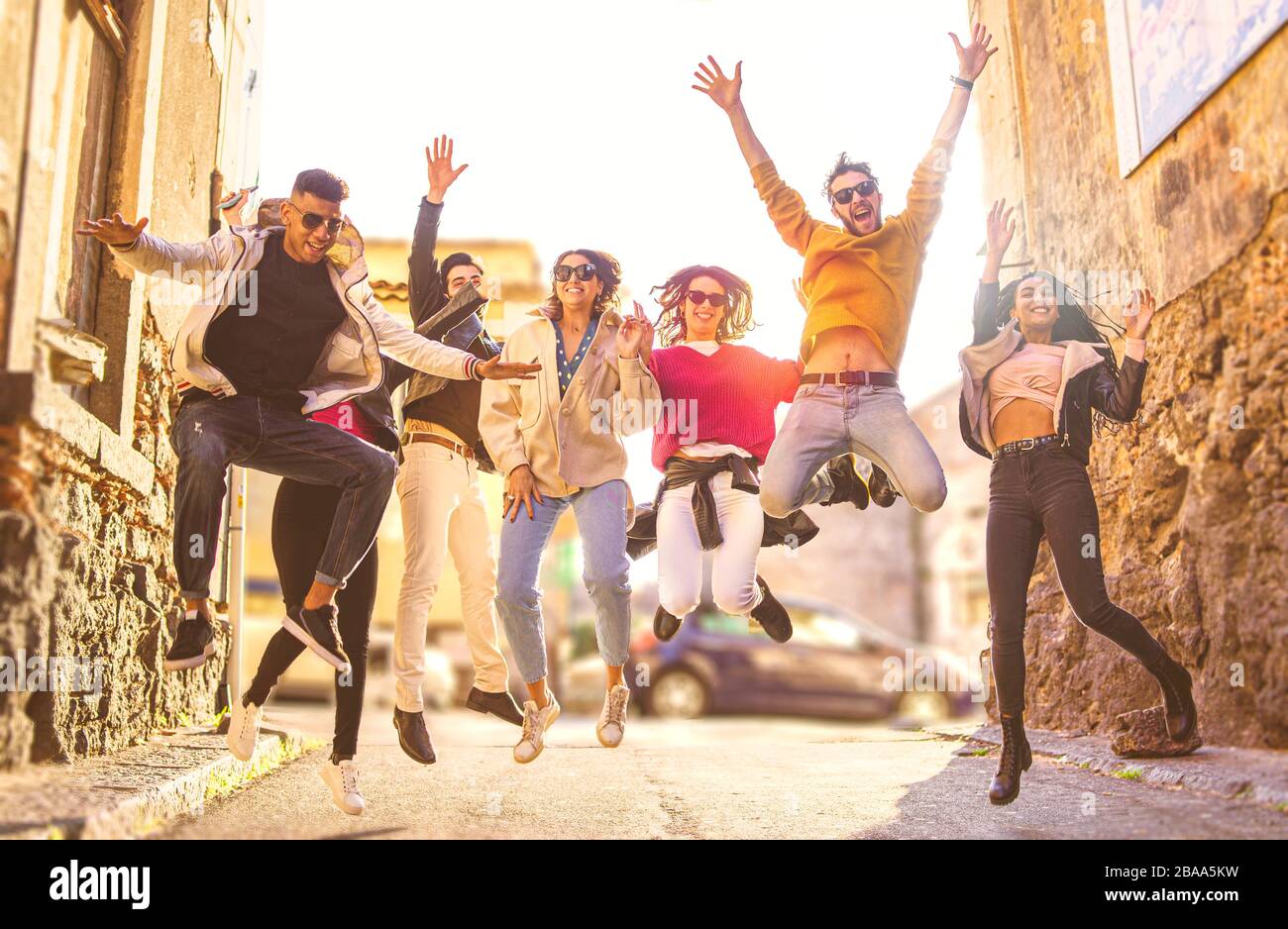 Multi-ethnic group of young people having fun together outdoors in ...