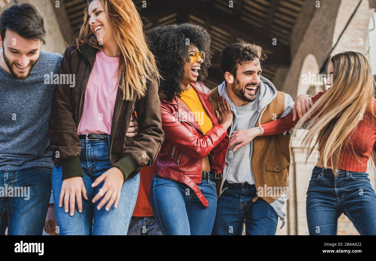 Multiracial group of millennials having fun walking in the city in the ...