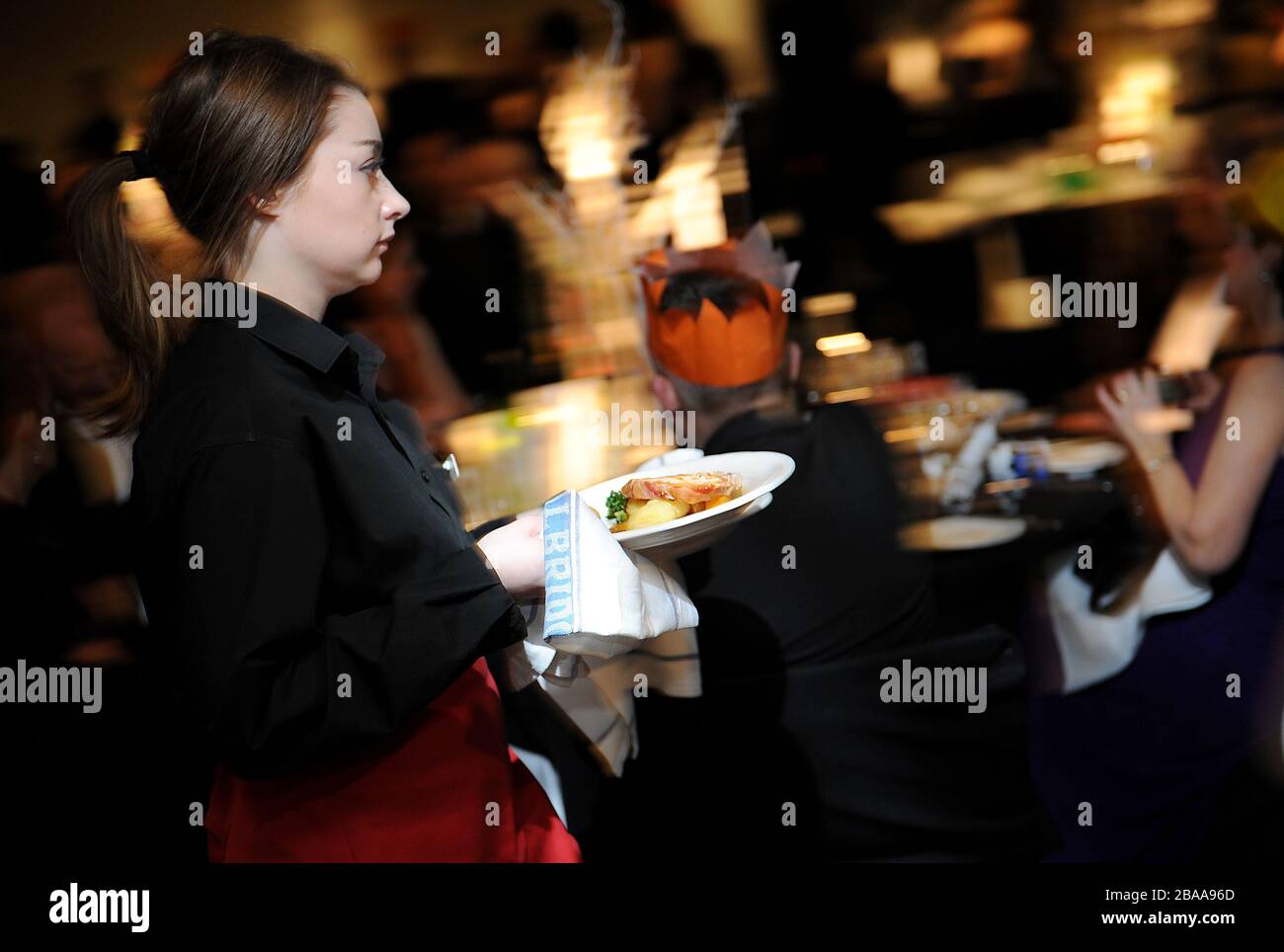 Waiting staff deliver food to guest's tables Stock Photo - Alamy
