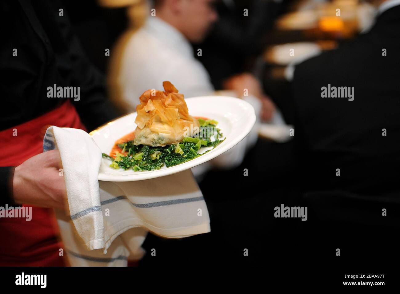 Waiting staff deliver food to guest's tables Stock Photo - Alamy