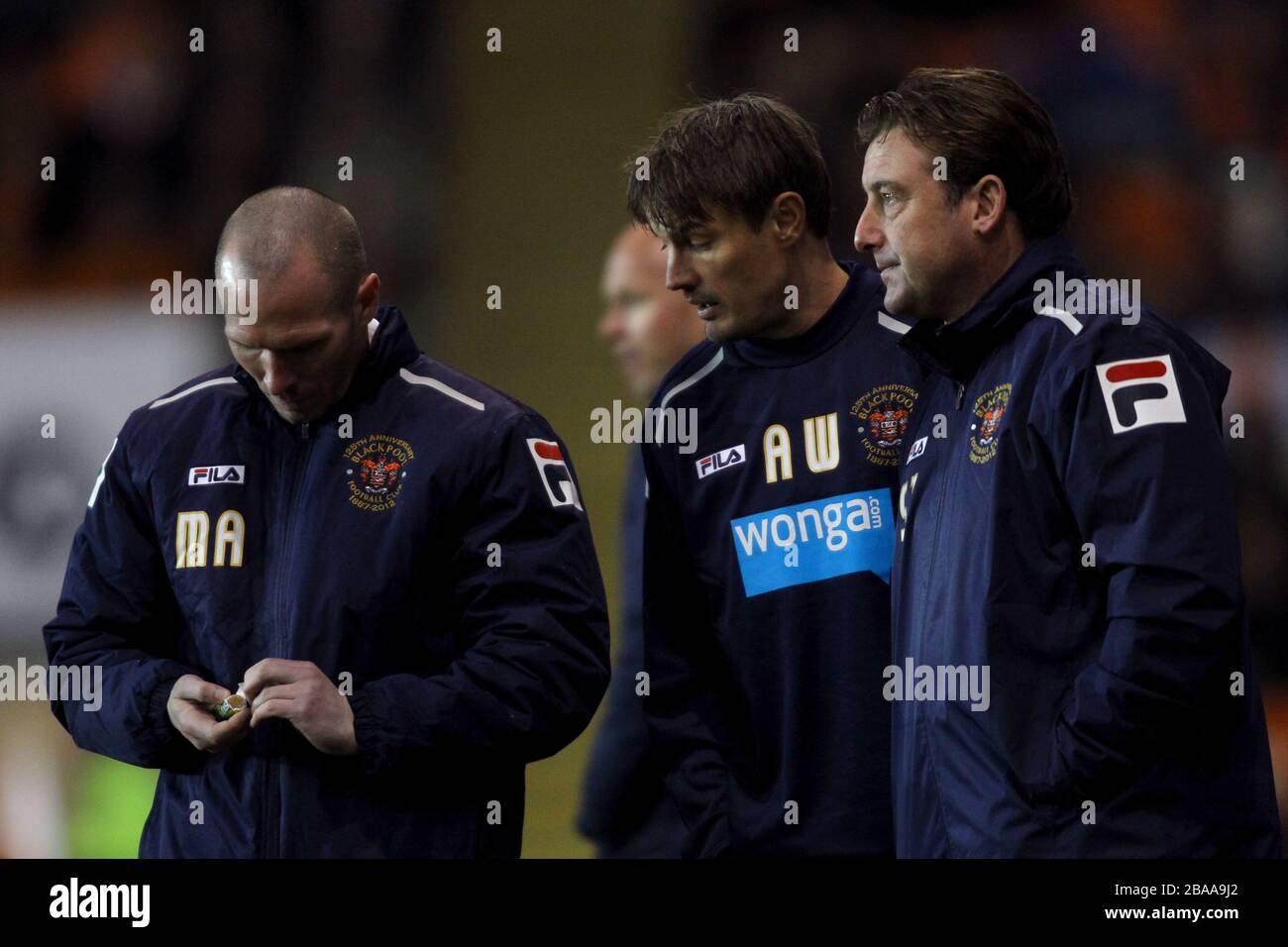 Blackpool manager Michael Appleton (left) speaks with staff members ...