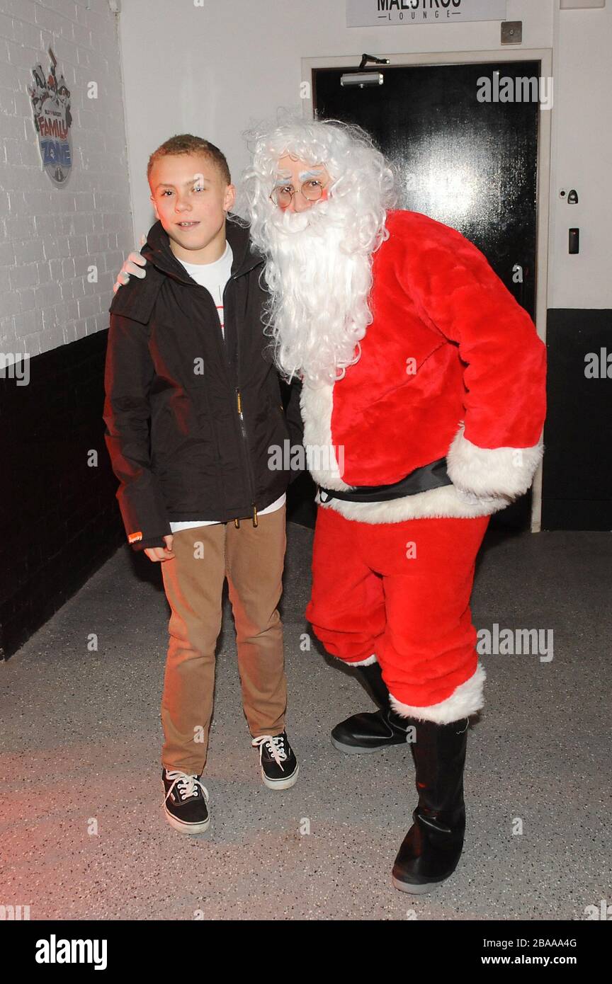 Santa claus with young fan during christmas at the cottage hi-res stock ...