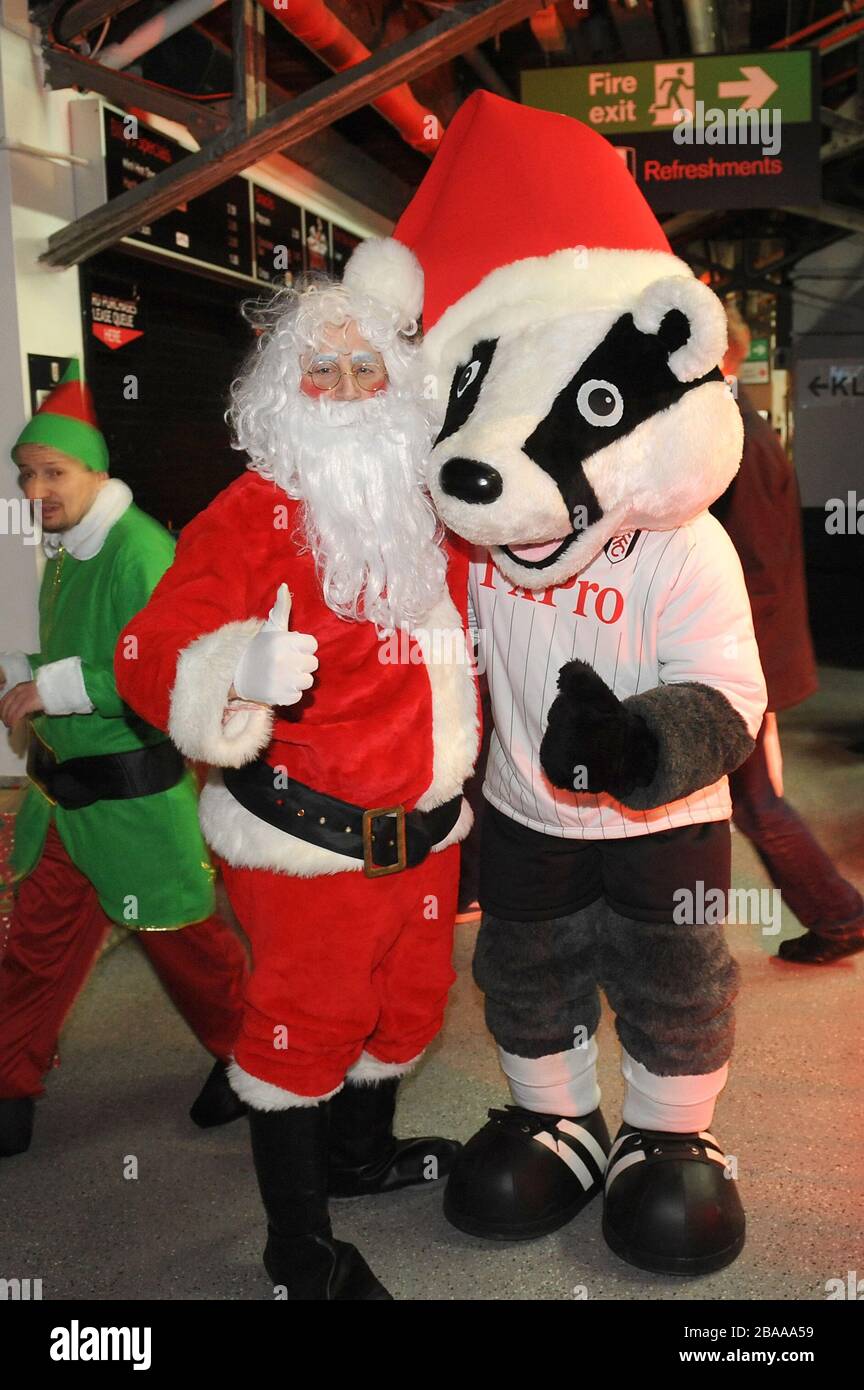 Fulham mascot Billy the Badger poses for photographs with Santa Claus ...