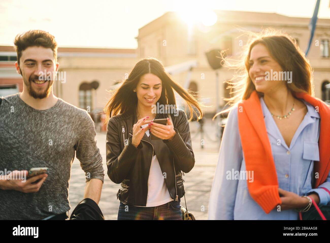 Millennials generation friendship having fun together walking and using ...