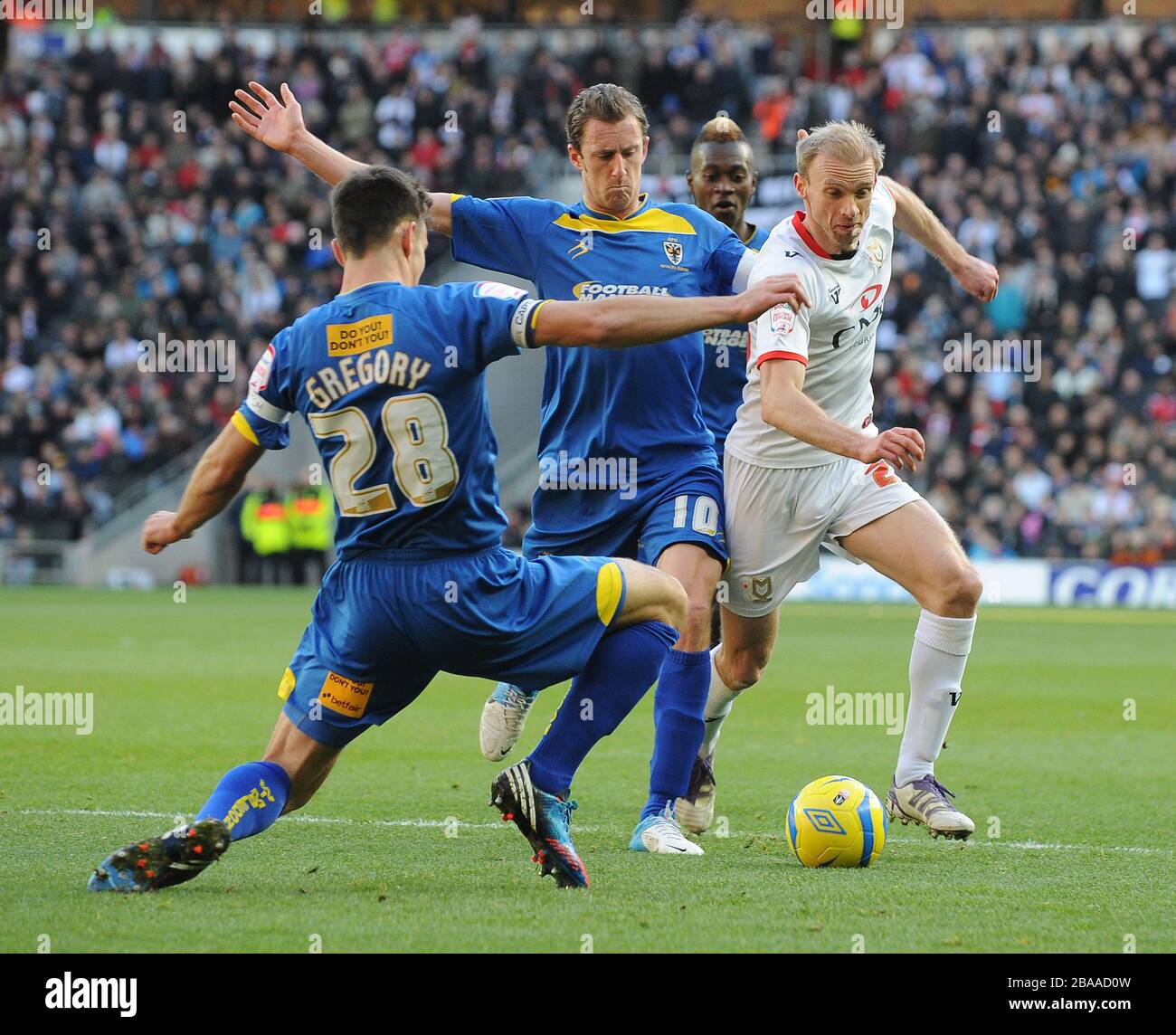 Milton Keynes Dons Luke Chadwick (right) battles for the ball with AFC Wimbledon's Jack Midson ...