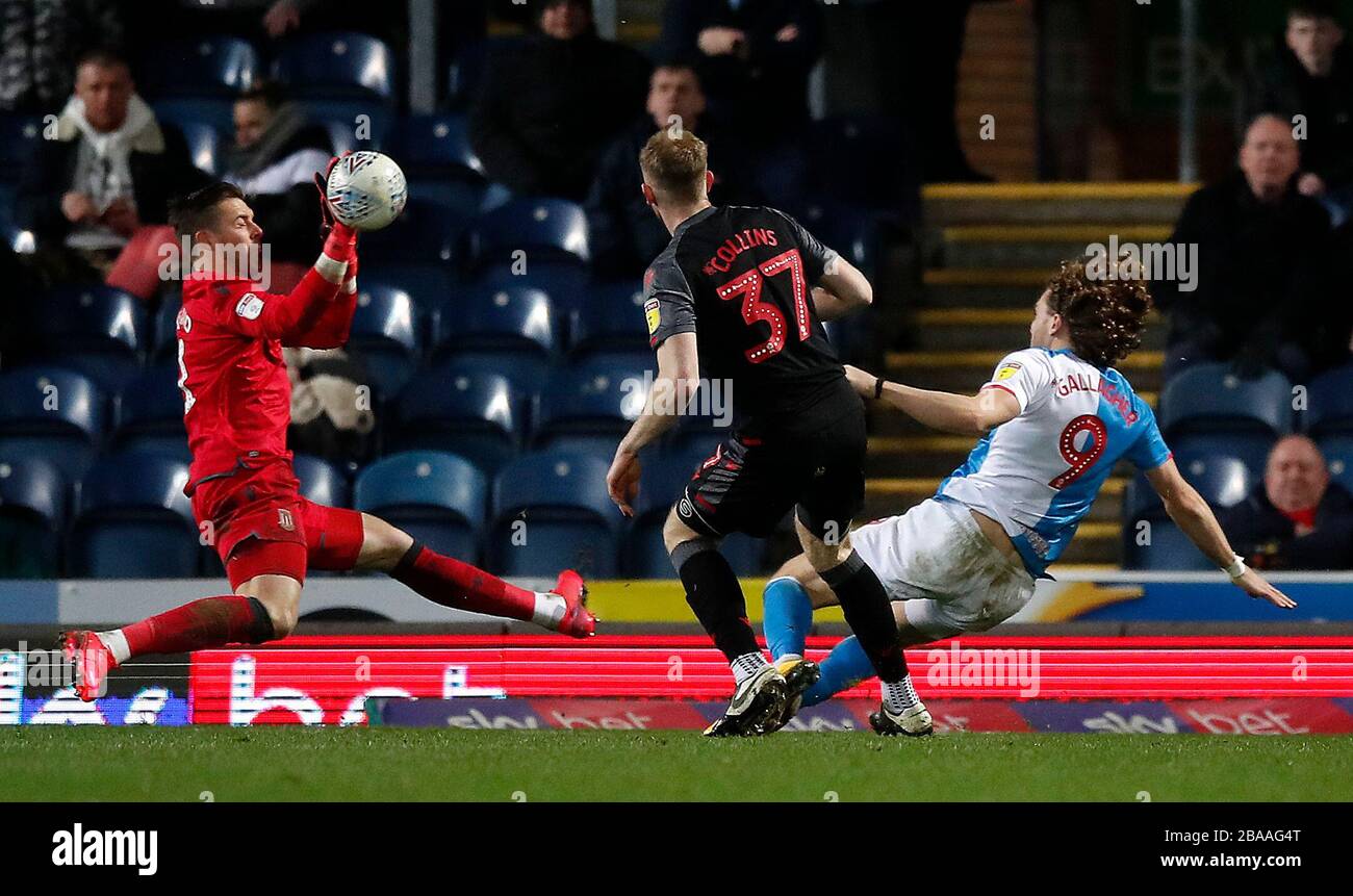 Stoke City goalkeeper Jack Butland saves from Blackburn Rovers' Sam ...