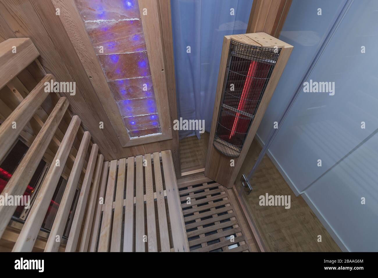 Infrared sauna interior close up view. Wooden walls and bench, ceramic ...