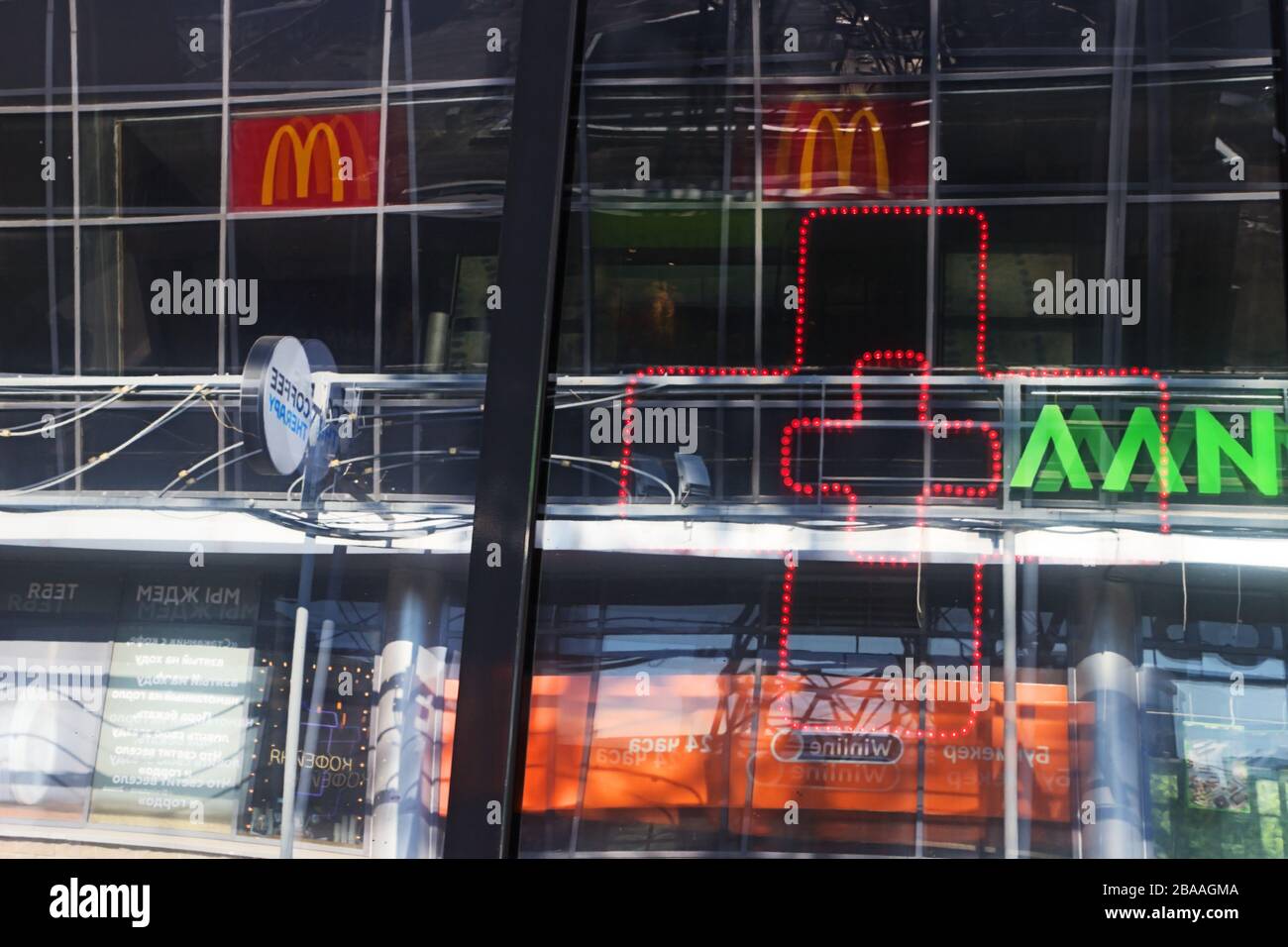 Reflection of a shopping centre in the drugstore window Stock Photo - Alamy