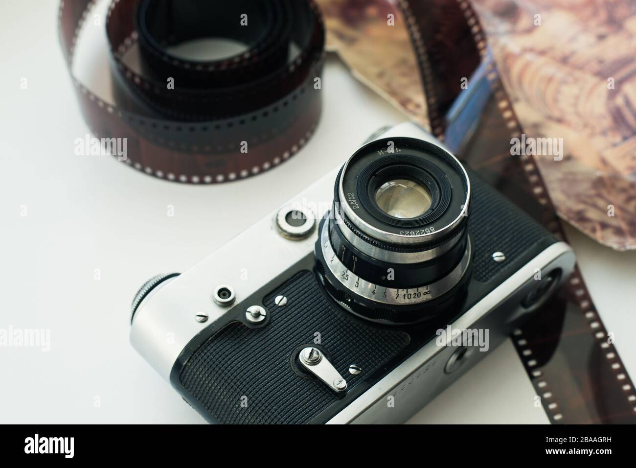 Old camera lies in photos next of photographic film Stock Photo - Alamy