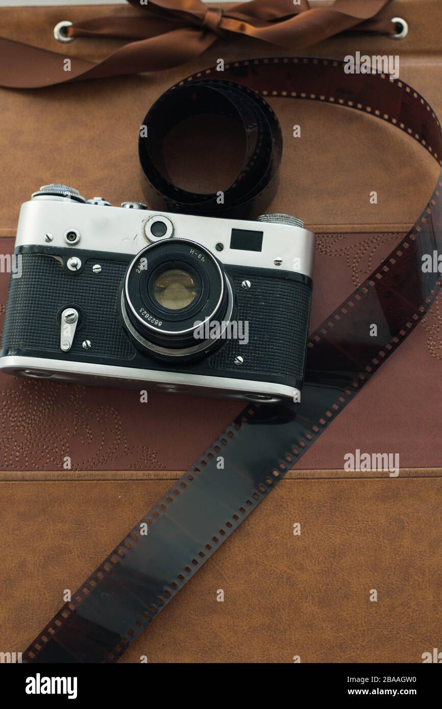 Old camera lies in photos next of photographic film Stock Photo - Alamy