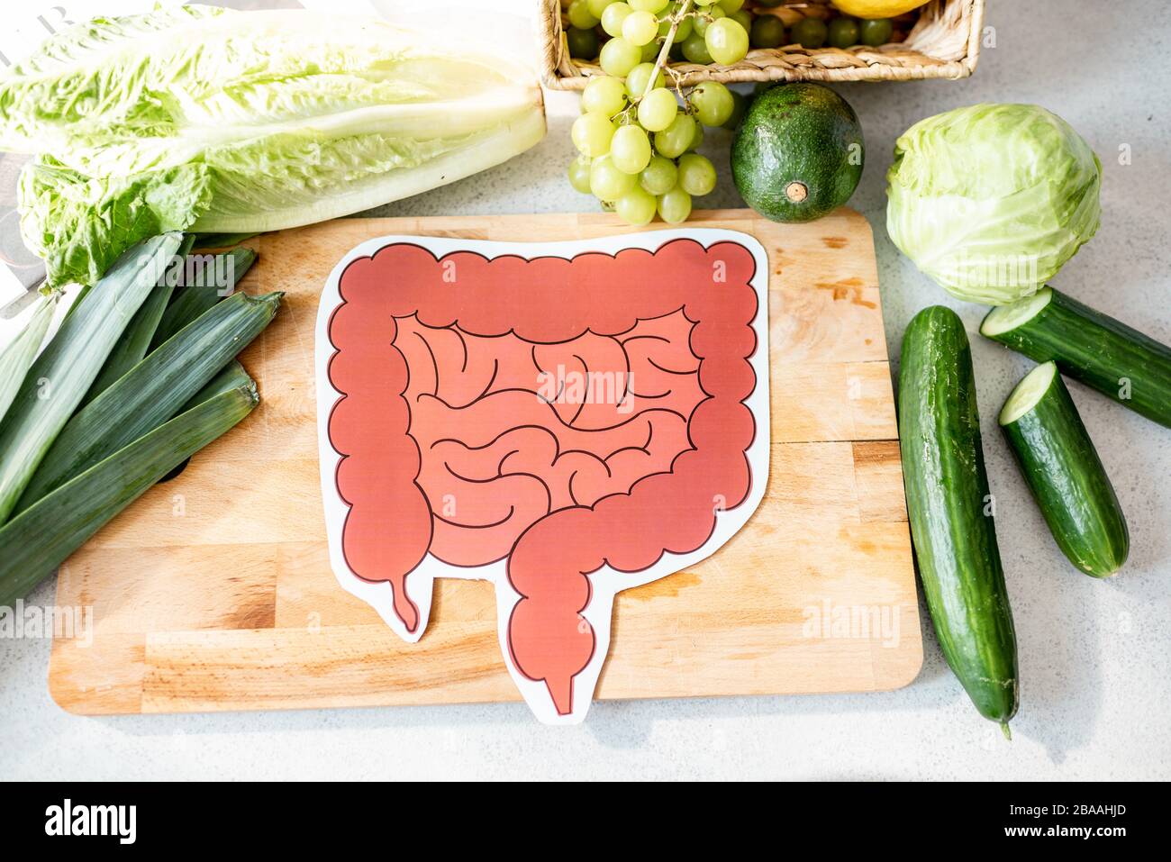 Human belly drawing on the cutting board with fresh green food, view ...