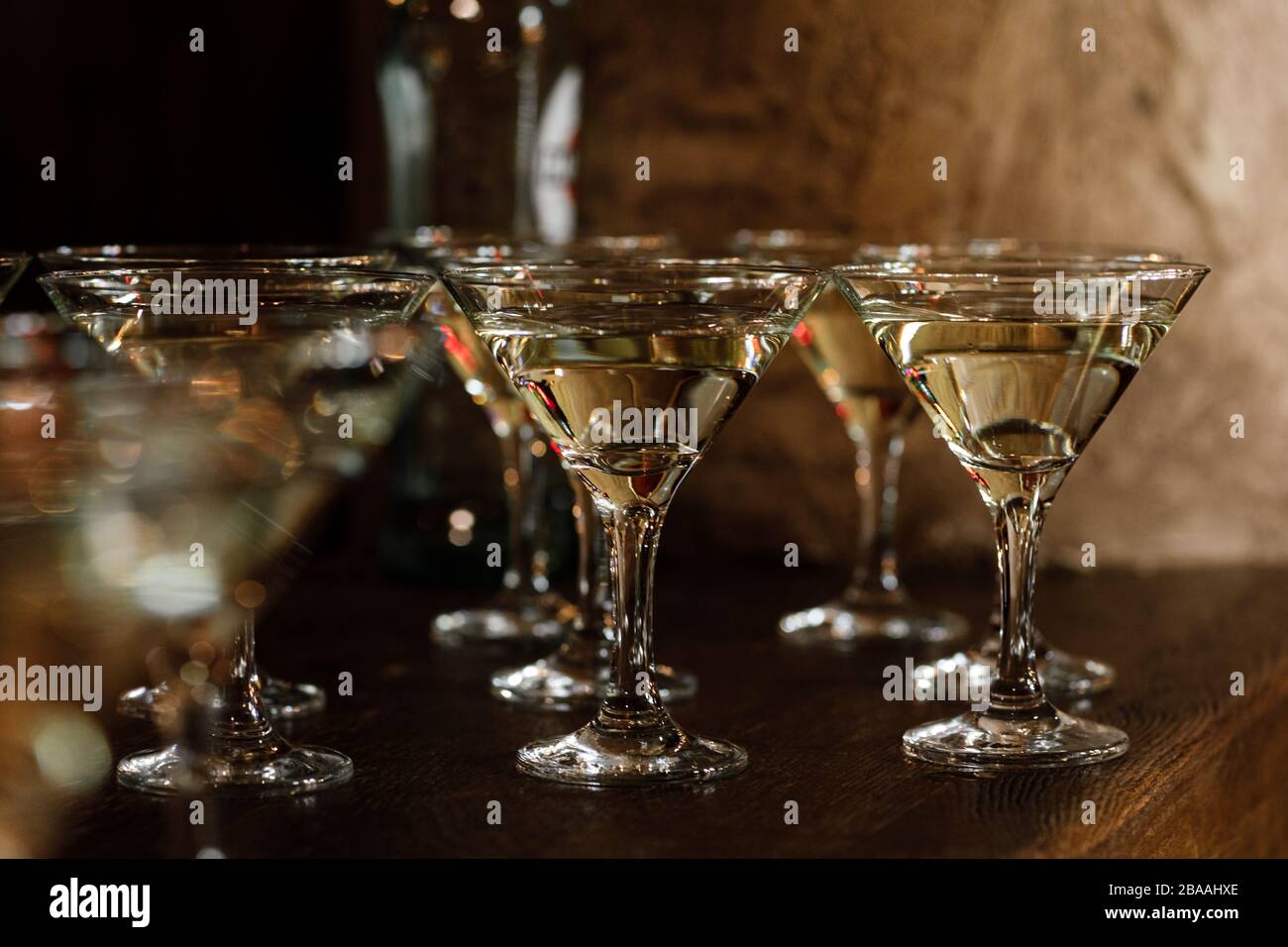 Martini glasses stand on a wooden stand. Martini glasses are on the bar ...