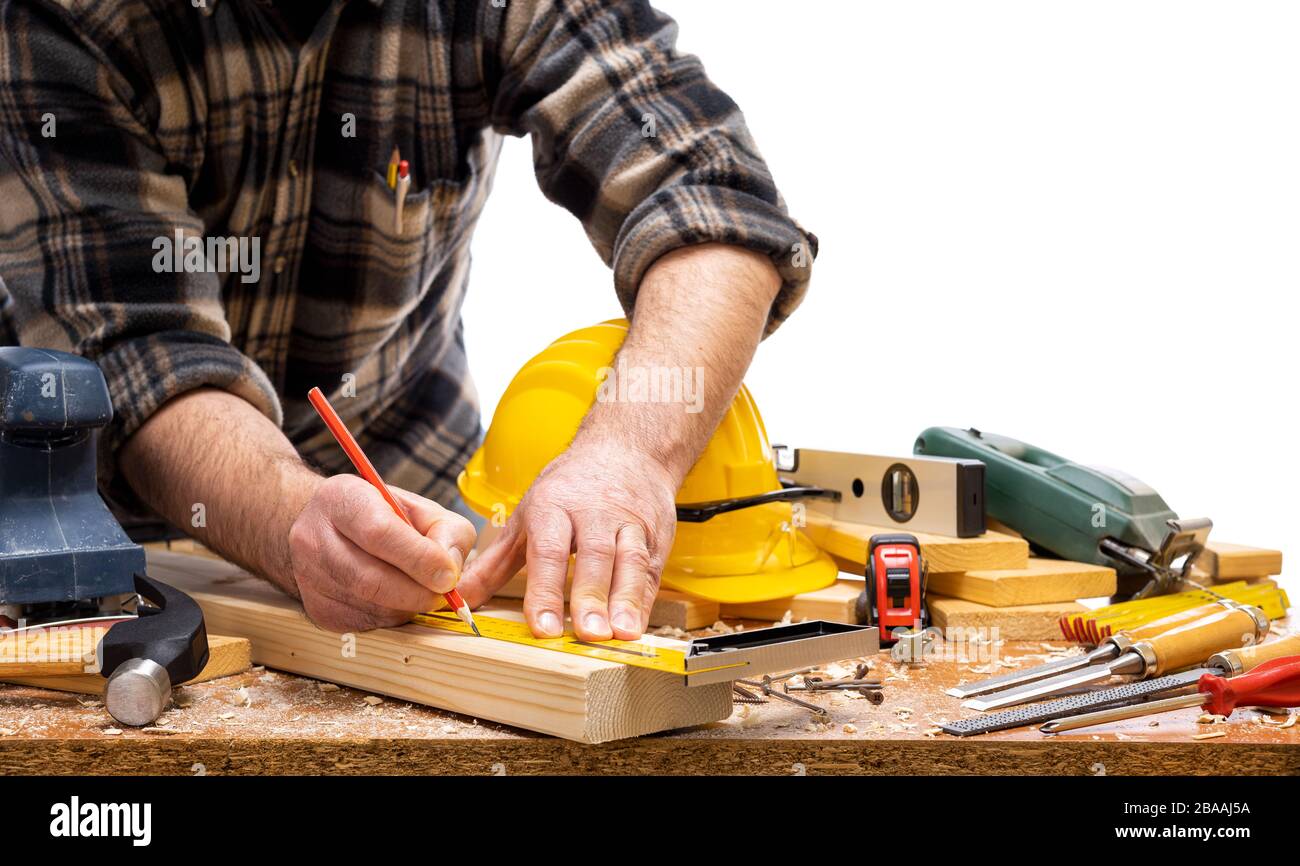Close-up. Carpenter with pencil and carpenter's square draw the cutting ...