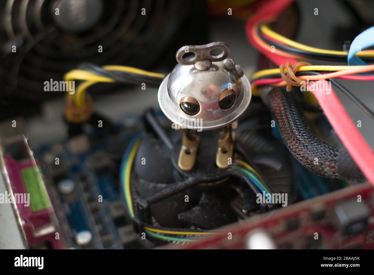 Beautiful photo of little robot repairing computer Stock Photo - Alamy