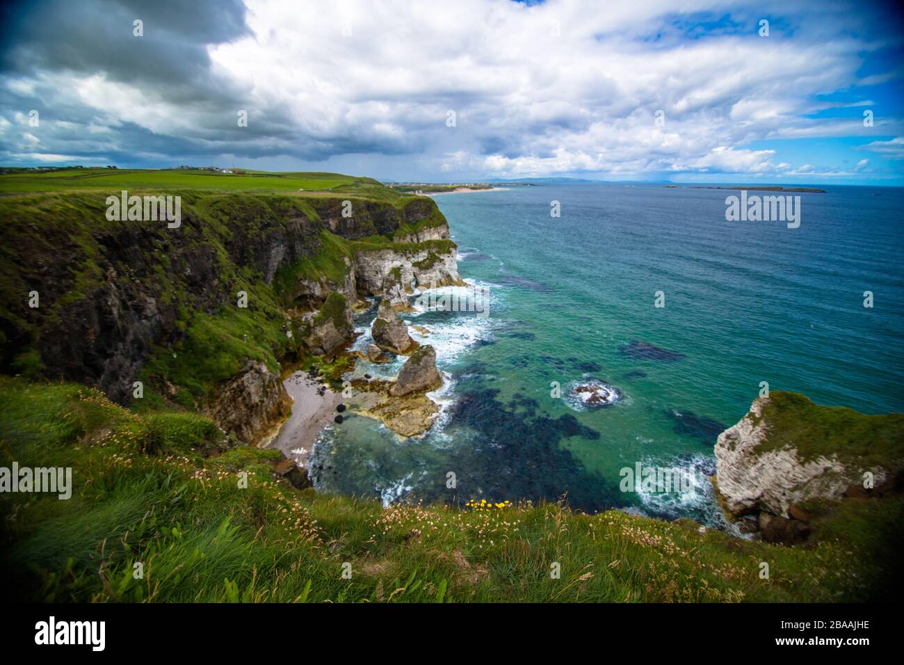 The beautiful green covered cliffs of Northern Ireland´s coast against ...