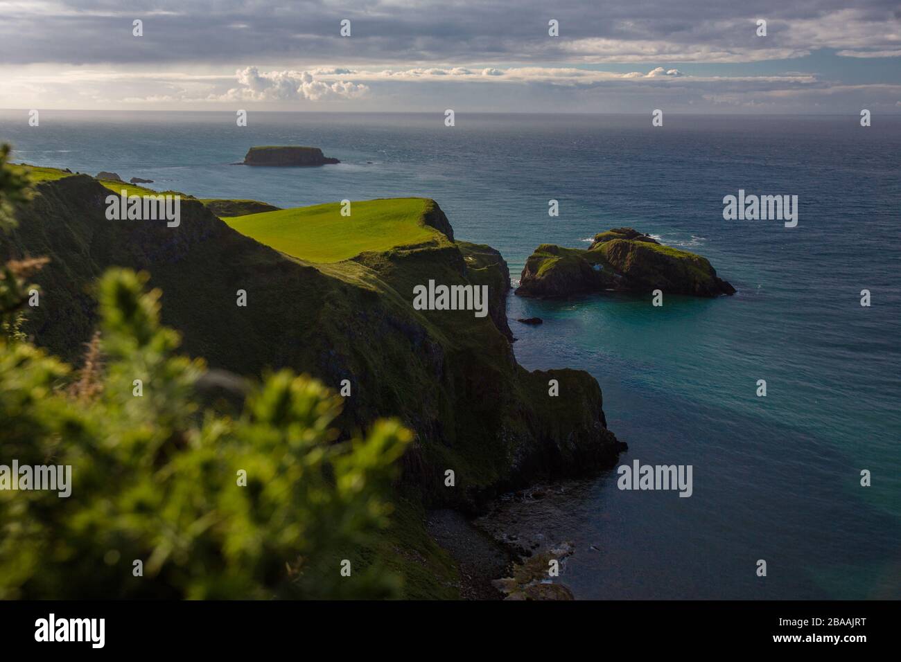 The beautiful green covered cliffs of Northern Ireland´s coast against ...