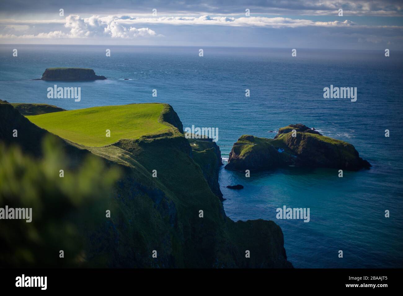 The beautiful green covered cliffs of Northern Ireland´s coast against ...