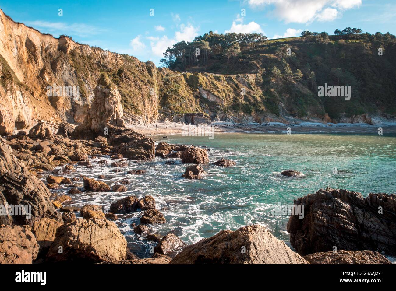 Cliff with big rocks with trees during daytime Stock Photo - Alamy