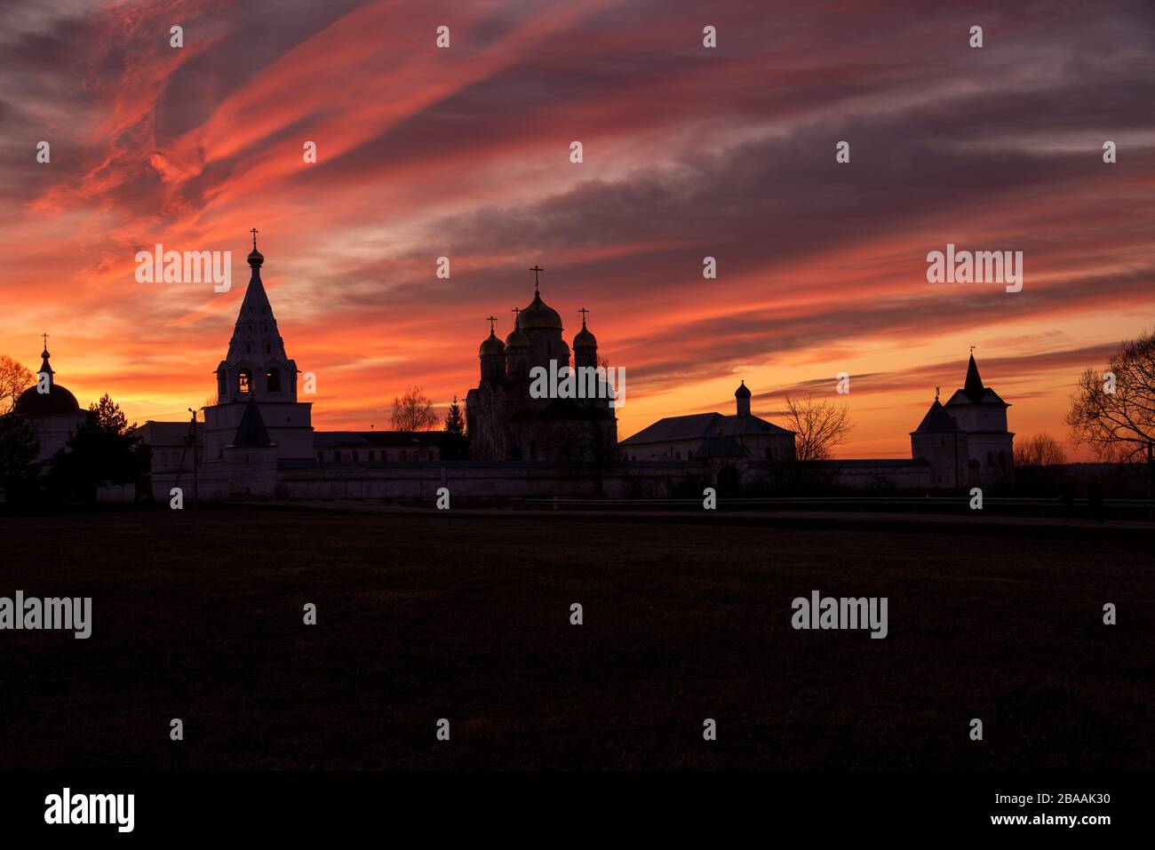 The black silhouette of the monastery against the bright sunset sky ...