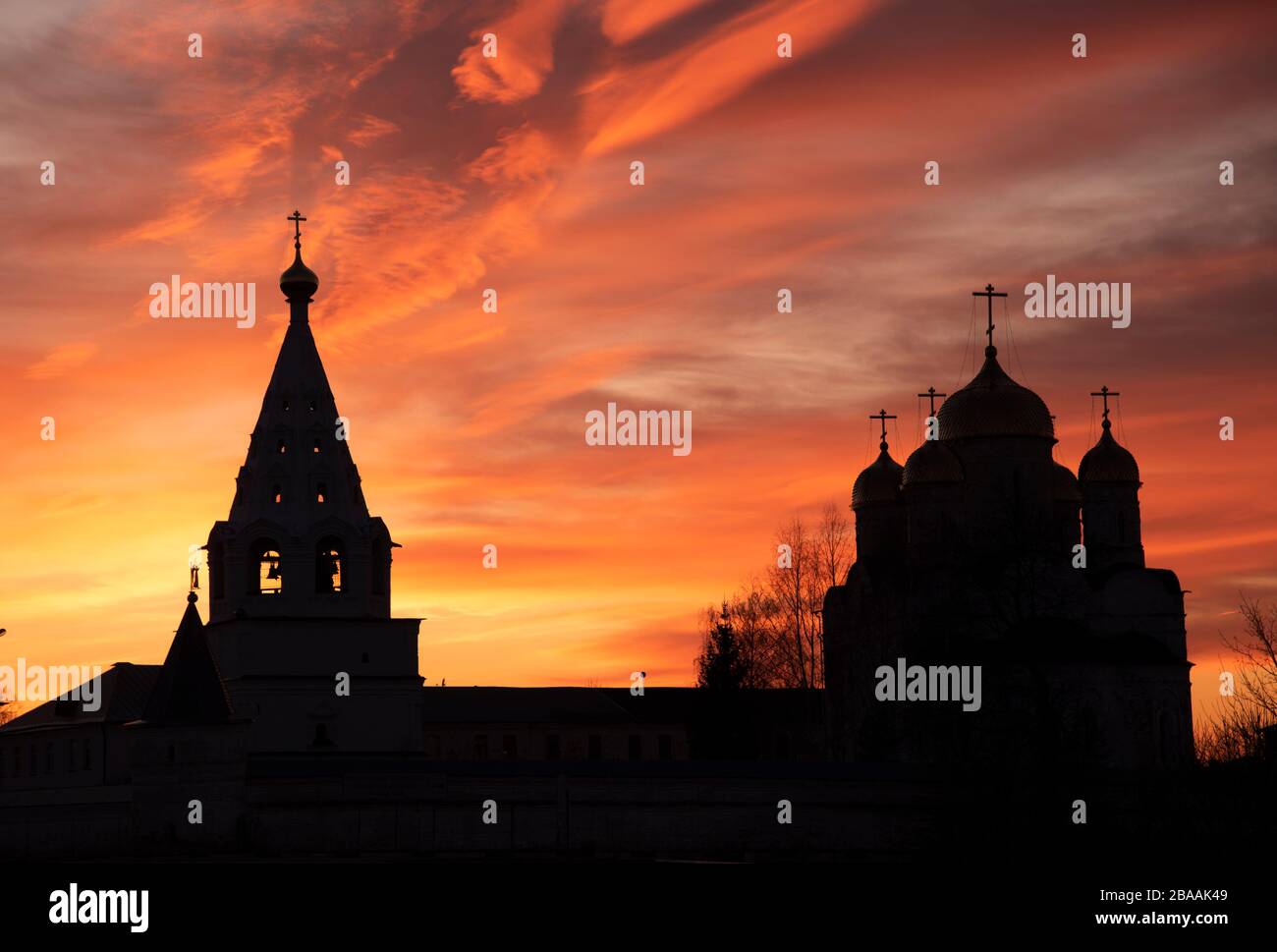 The black silhouette of the monastery against the bright sunset sky ...