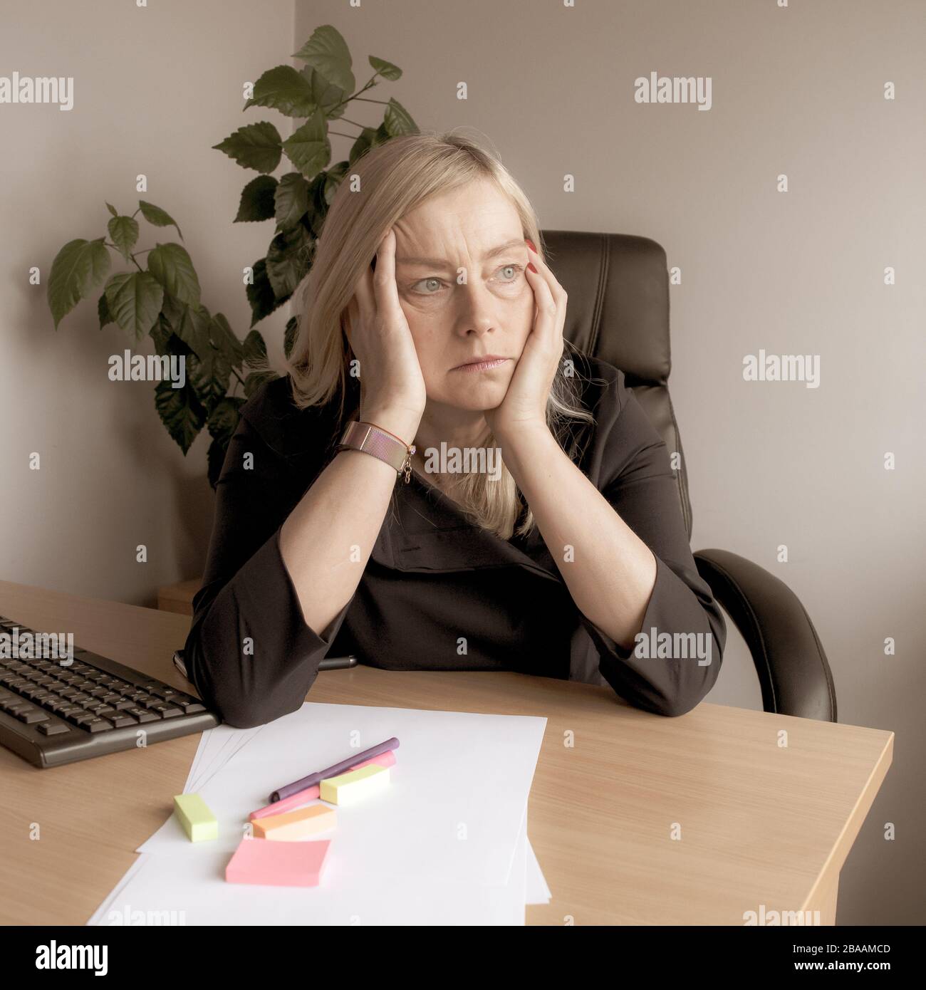 Stressed woman at work in office. Business person in empty office ...