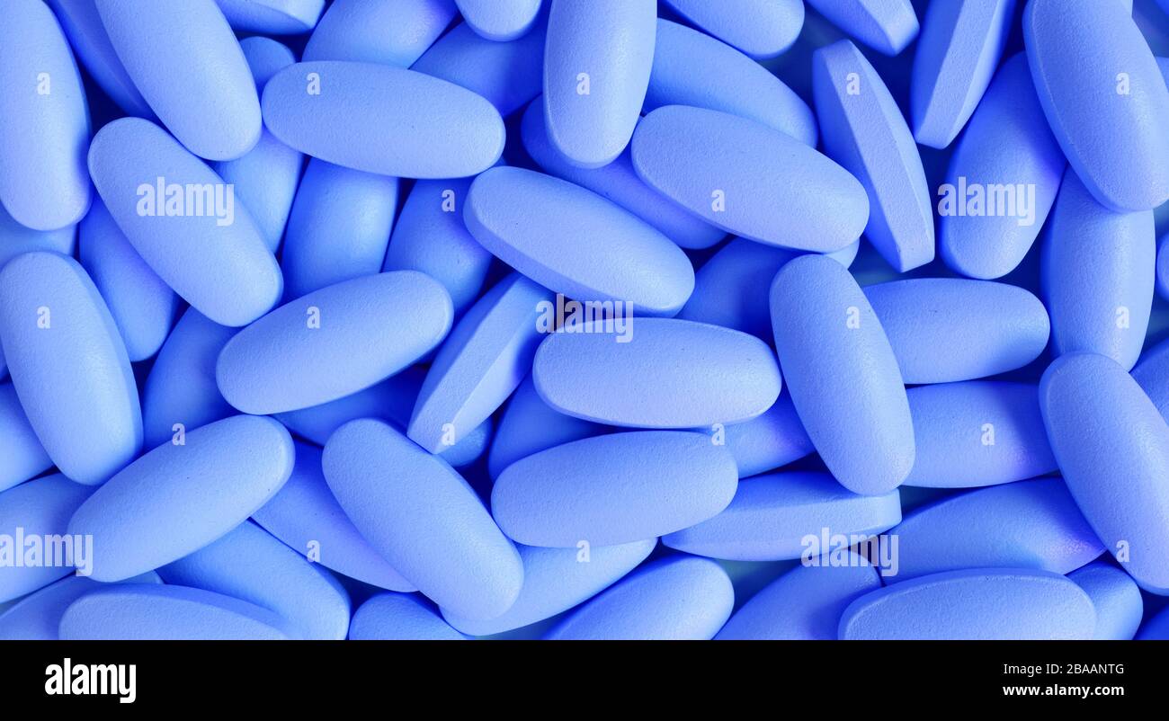 Heap of blue oval shaped pills for background and banner Stock Photo ...