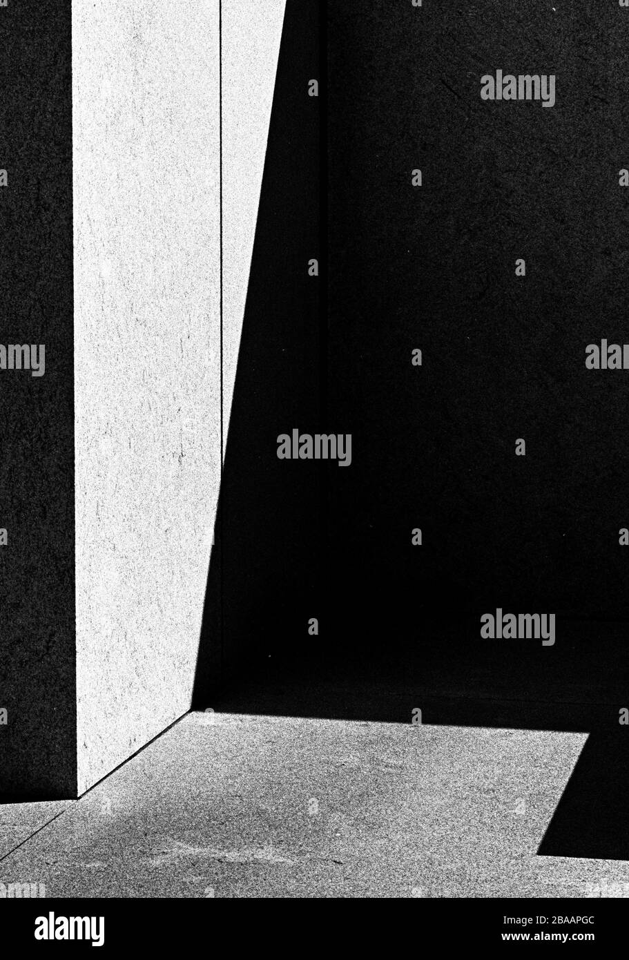 Greyscale vertical picture of a building corner with shadows - an ...