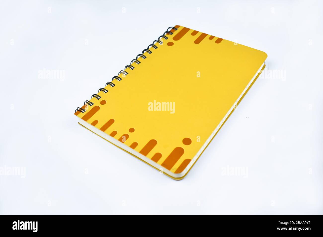 Portrait of an yellow note book diary with brown stripes before an ...