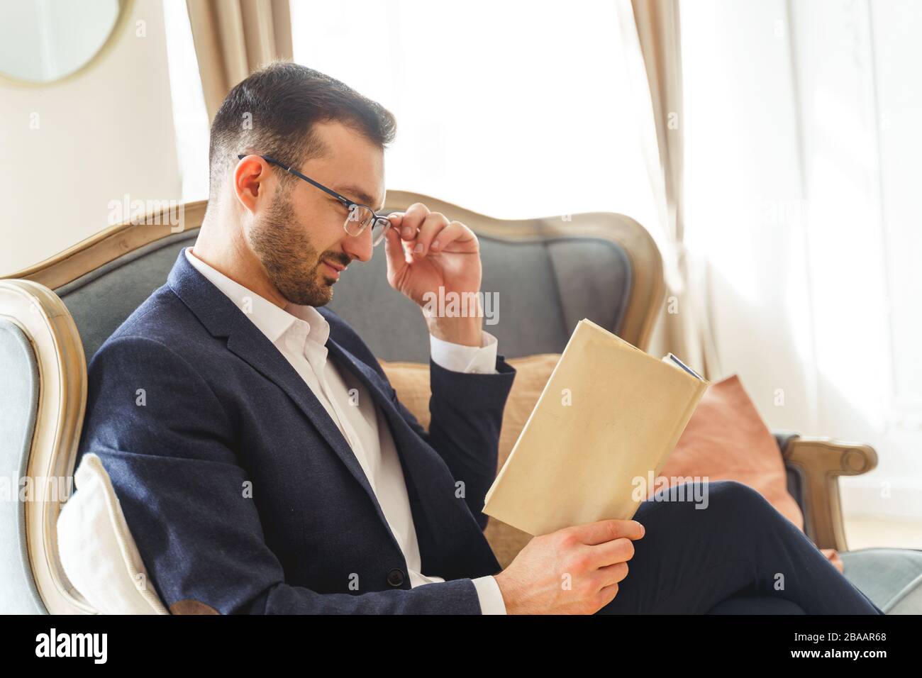 Focused handsome Caucasian man reading his notes Stock Photo - Alamy