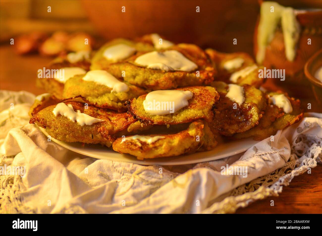 Plate with tasty potato pancakes on wooden rustic table. Potato ...