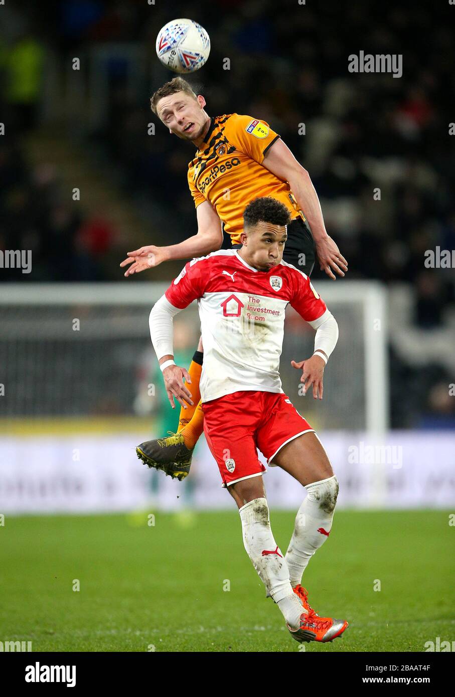 Hull City's Matthew Pennington (left) and Barnsley's Jacob Brown battle ...