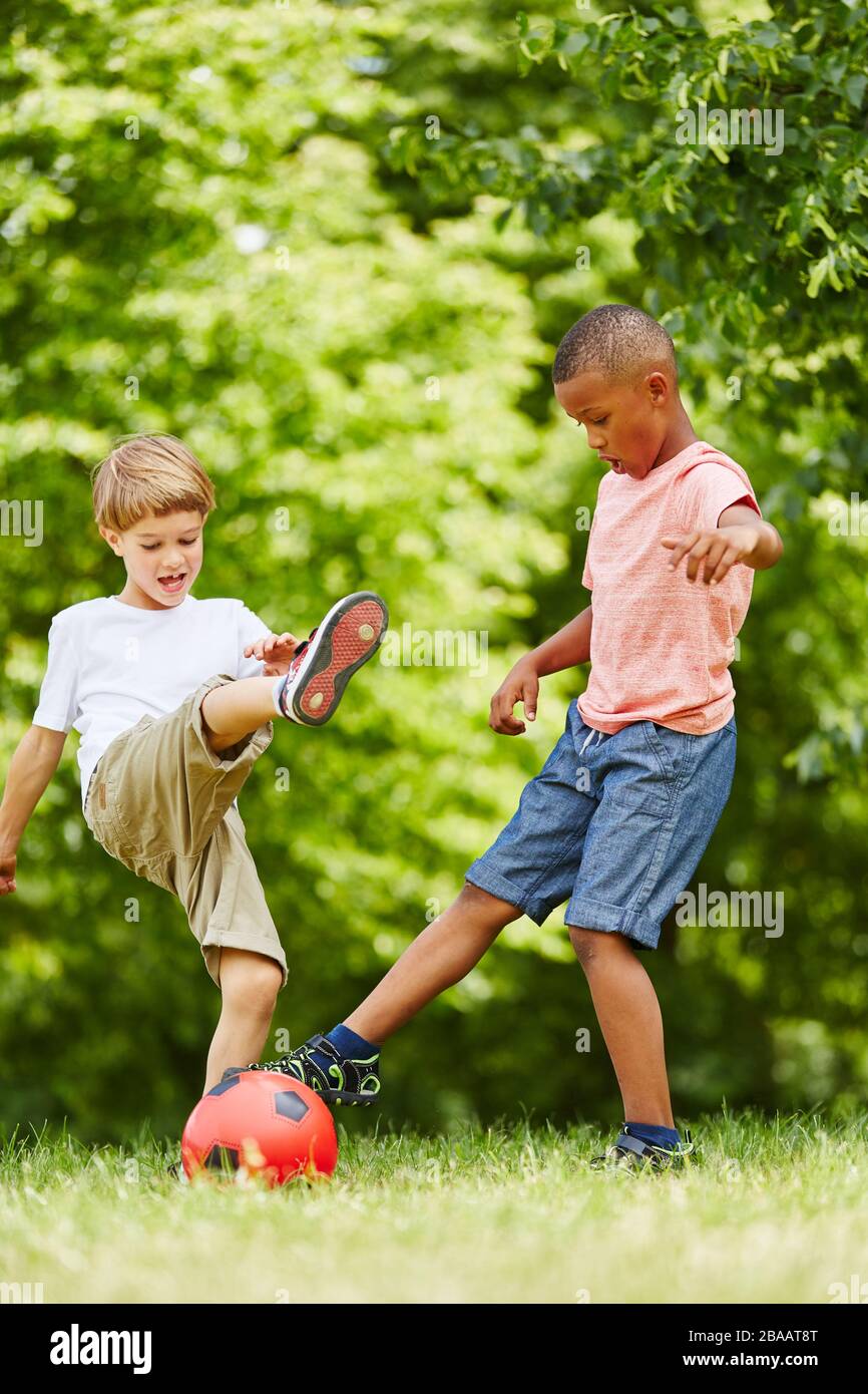 Two boys play football together in the club in summer Stock Photo - Alamy