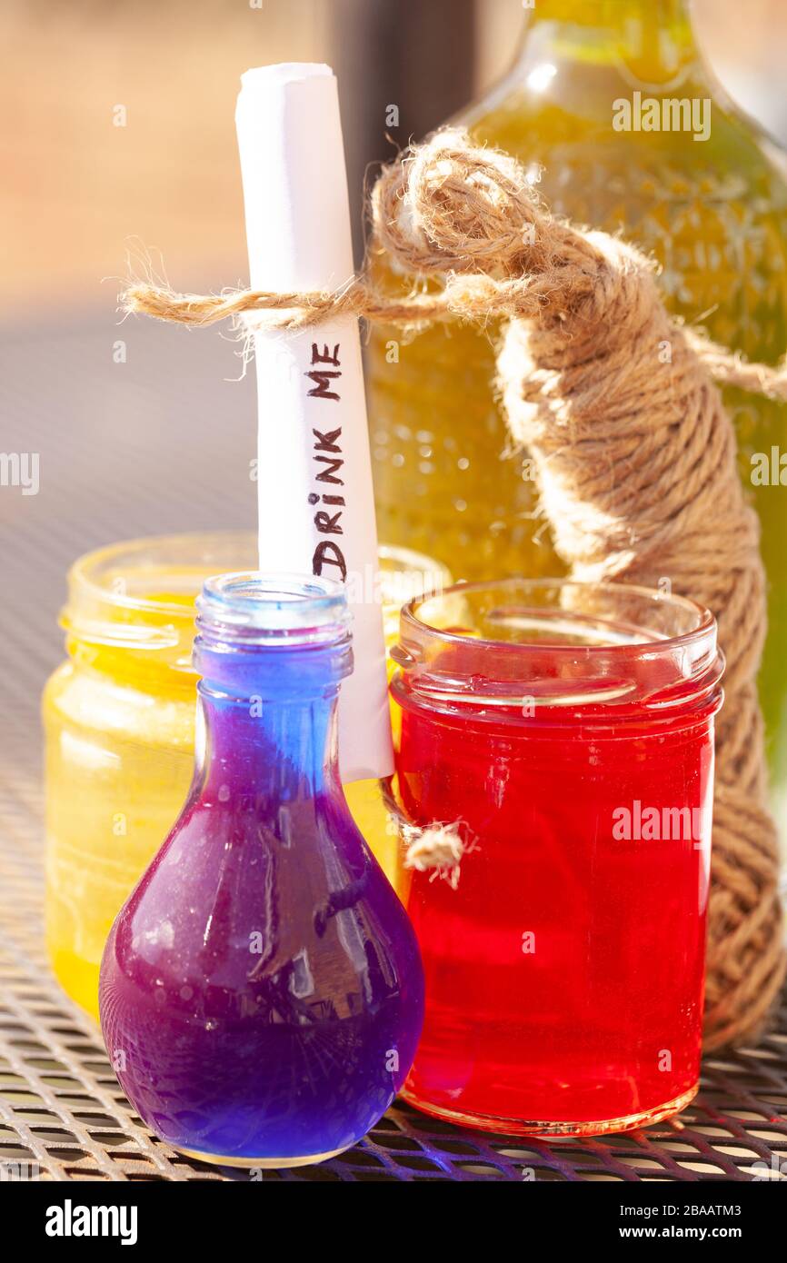 "Drink Me" still life - Glass jars & bottles containing red blue and ...