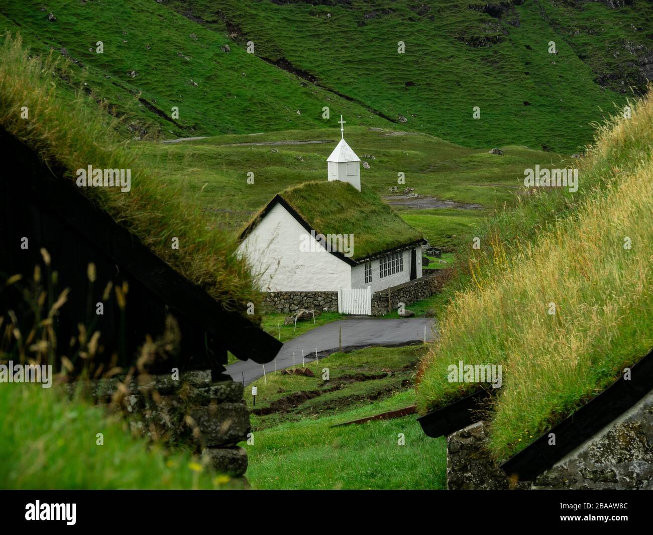 Faroe Islands. White Church with grass roof in the village of Saksun on ...