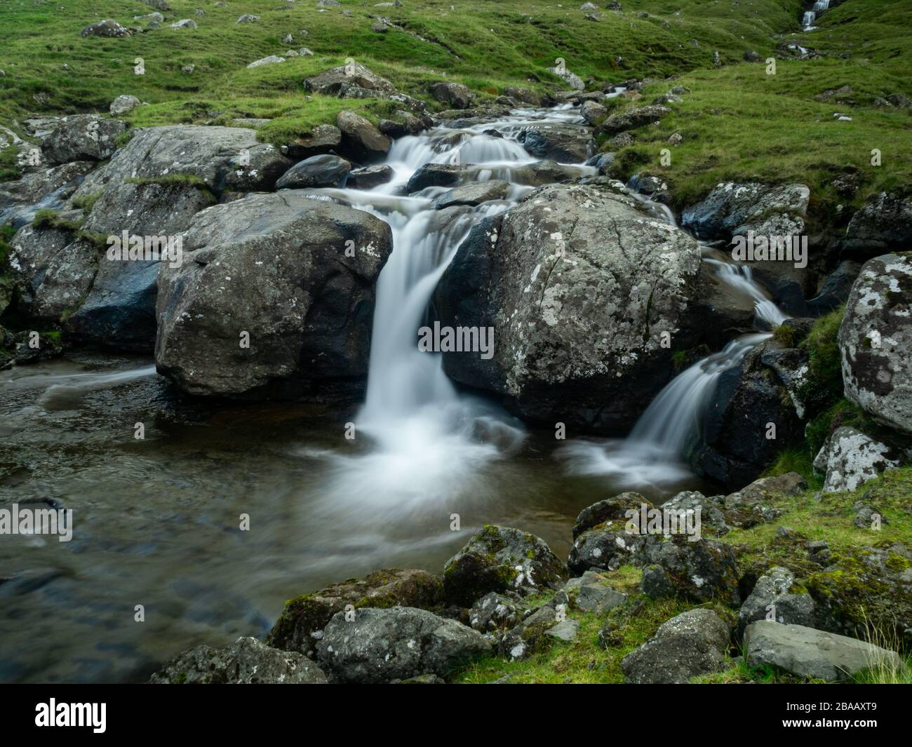 Faroe Islands, one of many waterfalls on road to abandoned town Muli ...