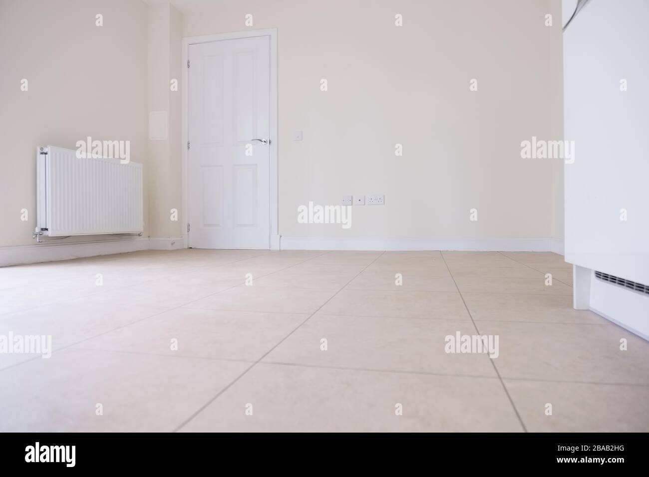 New white radiator white on pale wall house interior Stock Photo - Alamy