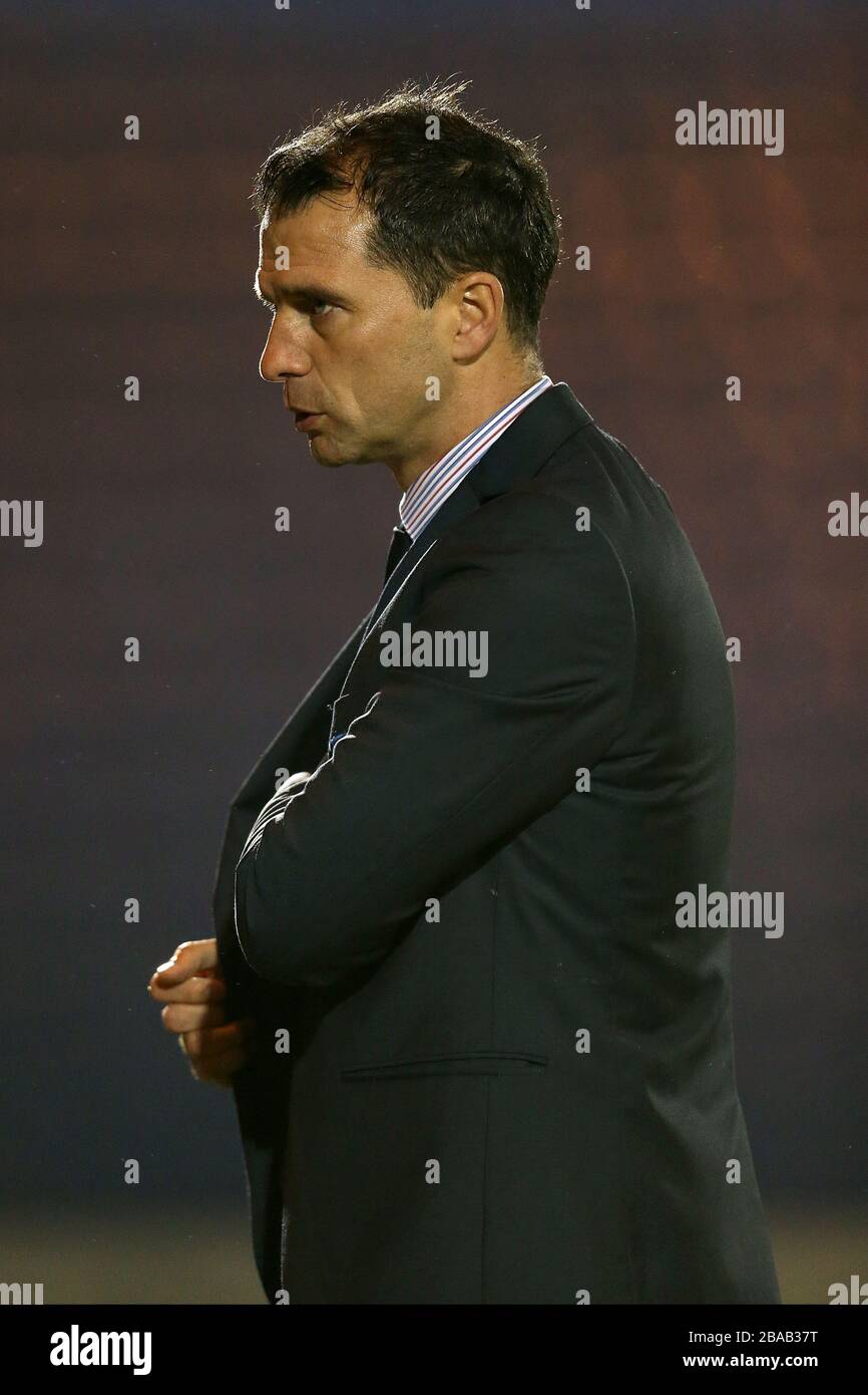 Colchester United manager Joe Dunne turns away from the action on the ...