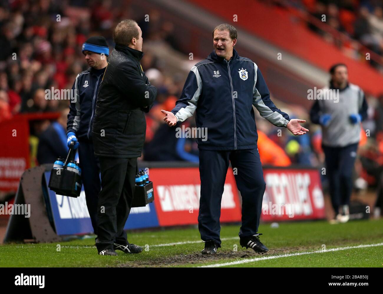 Huddersfield Town manager Simon Grayson speaks with the fourth official ...