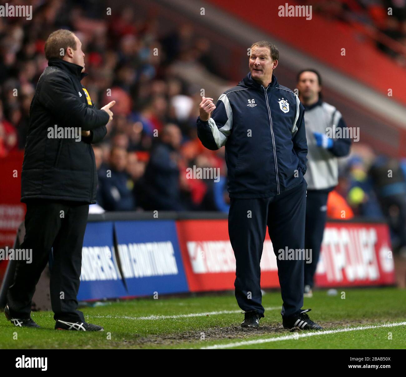 Huddersfield Town manager Simon Grayson speaks with the fourth official ...