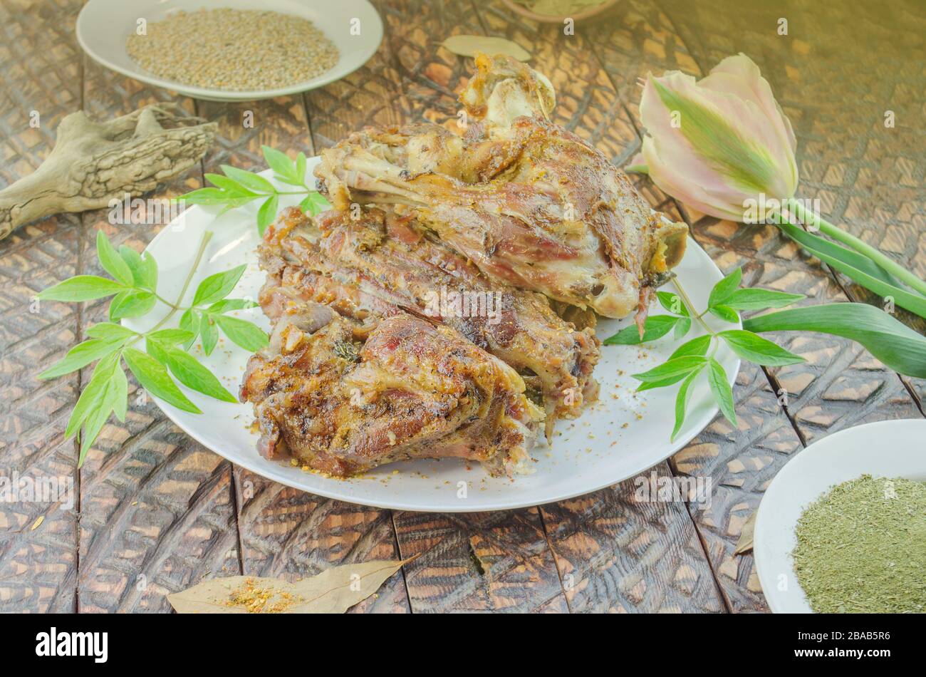 Grilled meat on white plate against a rustic background Stock Photo - Alamy