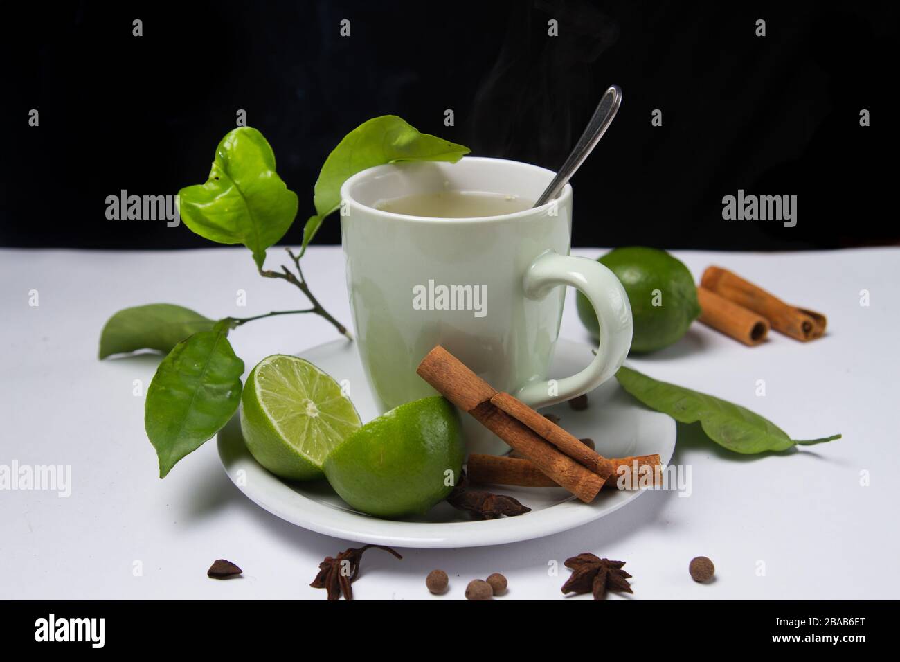 hot lemon tea cup beverage with lemon spices on white table black ...